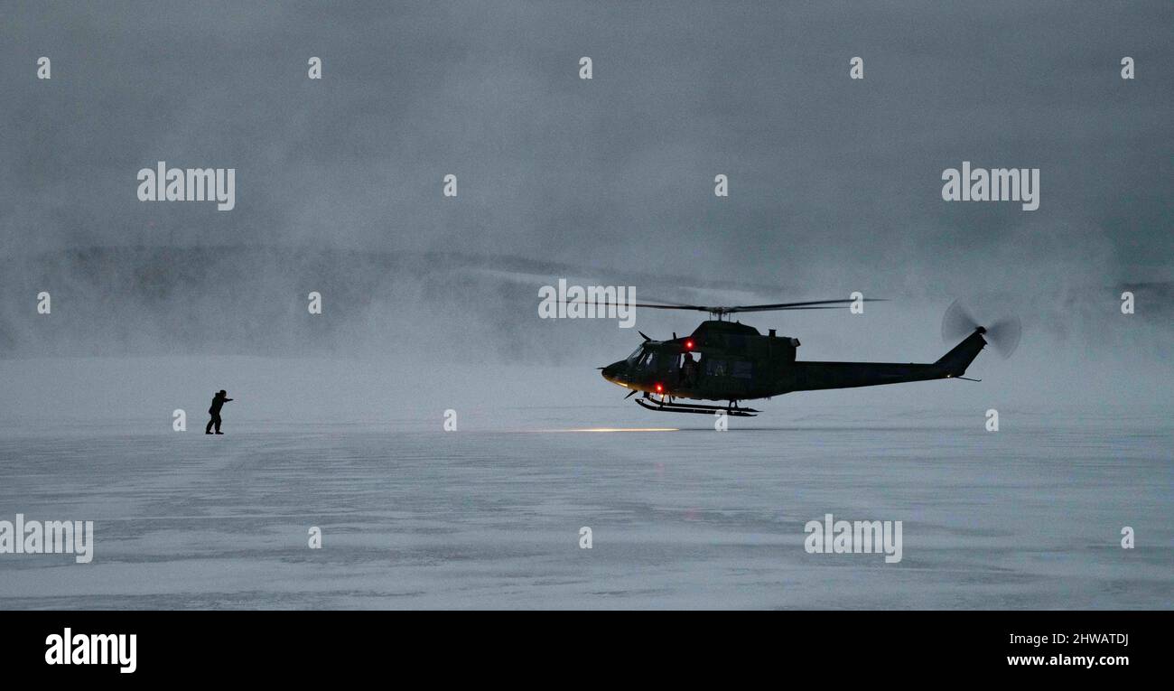 Corporal Jaron Gilbert marshalls a CH146 Griffon Helicopter in arctic ...