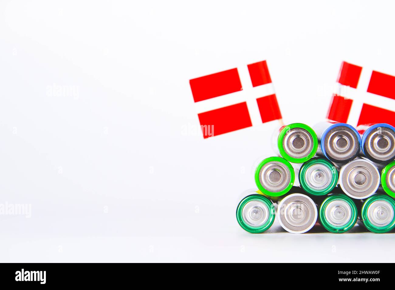 Battery. A lot of batteries on the background of the flag of dennmark ...