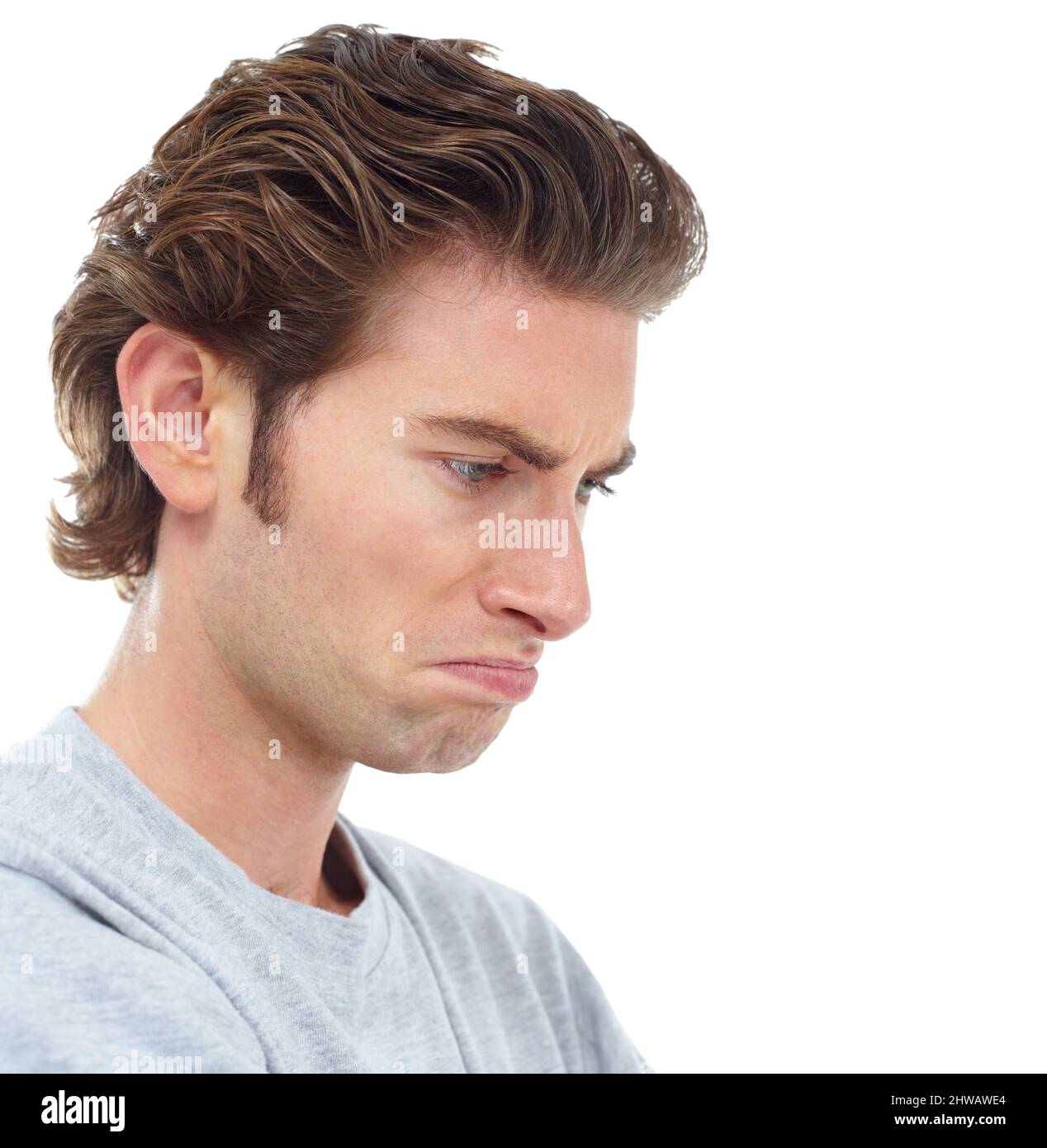 Bad loser. Handsome young man looking down disappointedly - profile ...