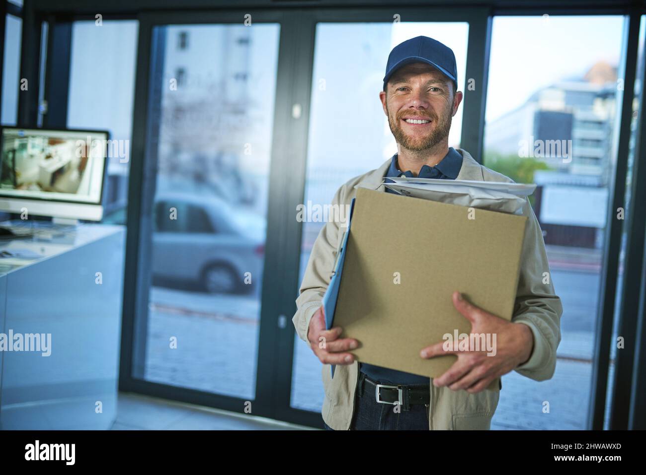 Did someone order a package. Shot of a young man making a home delivery ...