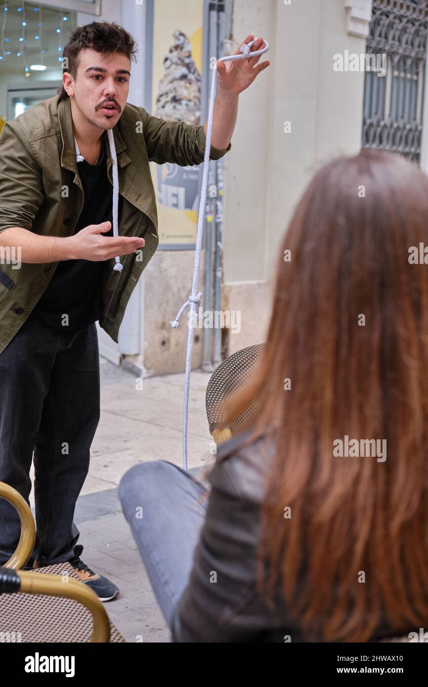 Street magician doing a rope trick Stock Photo - Alamy