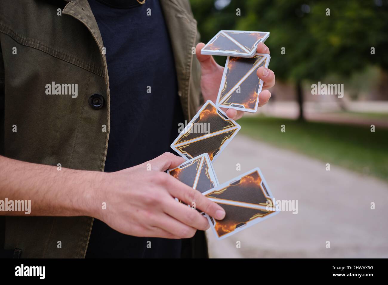 magician showing trick with playing cards Stock Photo - Alamy