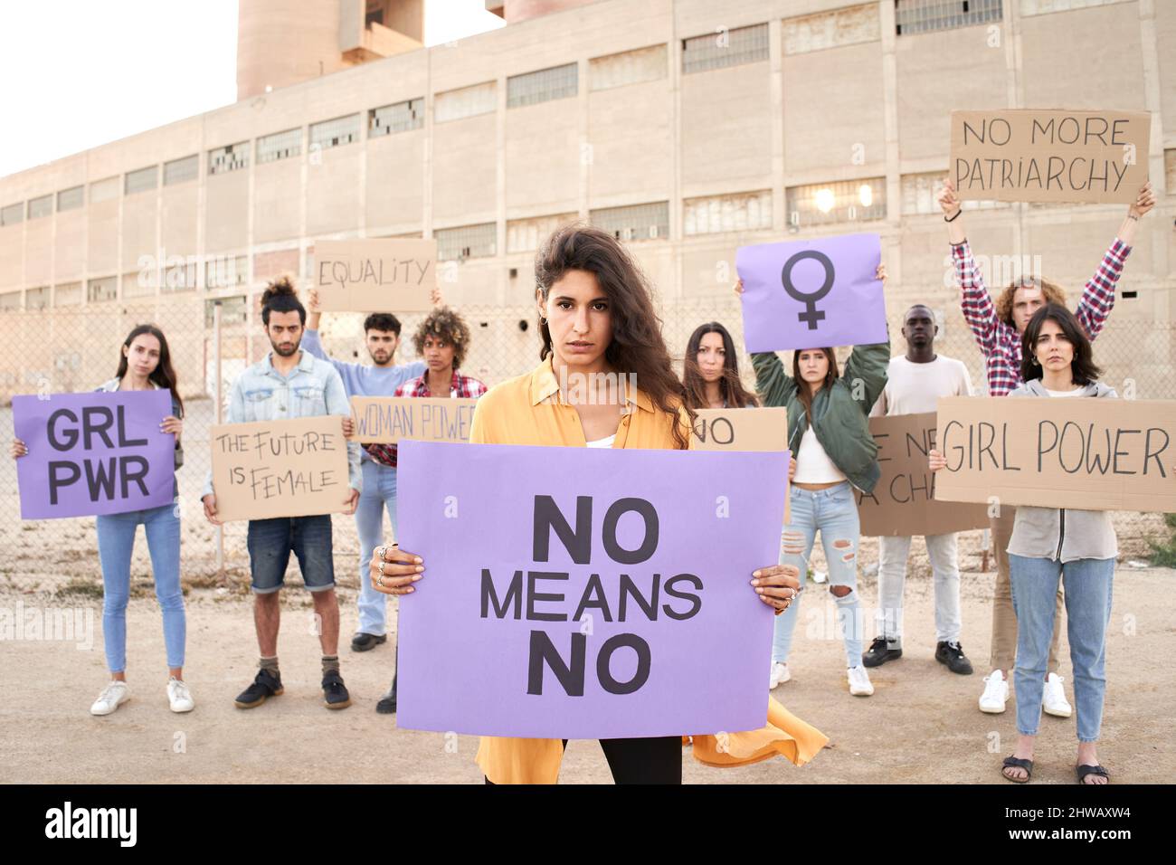 Group of people holding placard with word near feminist Stock Photo - Alamy