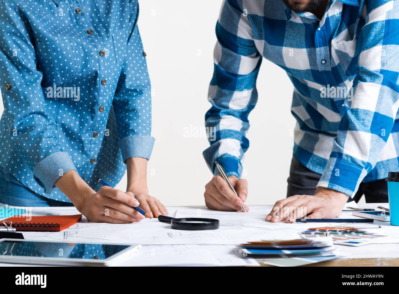 Man writing with pen on technical drawing Stock Photo - Alamy