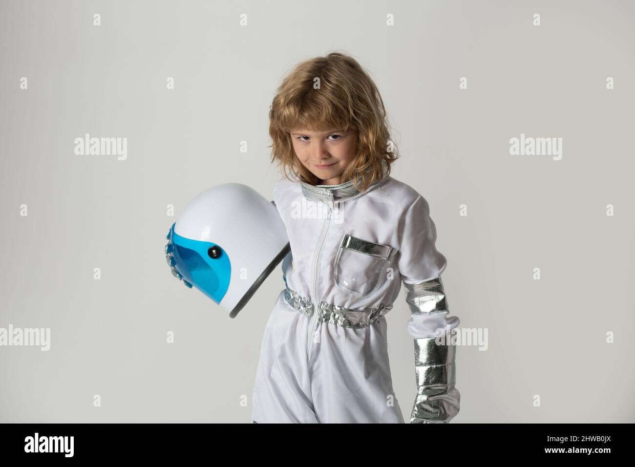 Small child wants to fly an in space wearing an astronaut helmet. Copy ...
