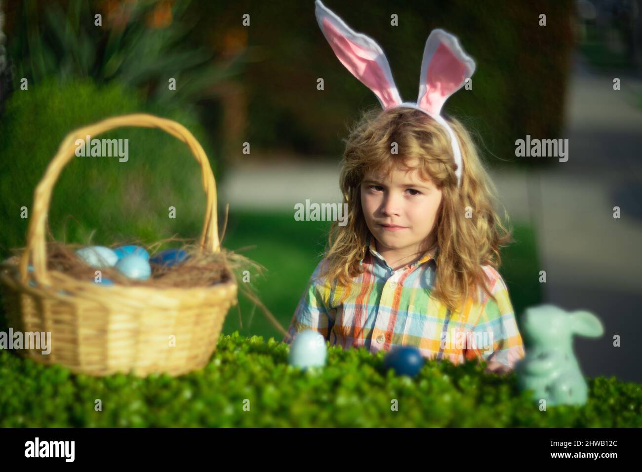 Child with rabbit ears, Easter holidays. Kid hunting Easter eggs. Cute ...