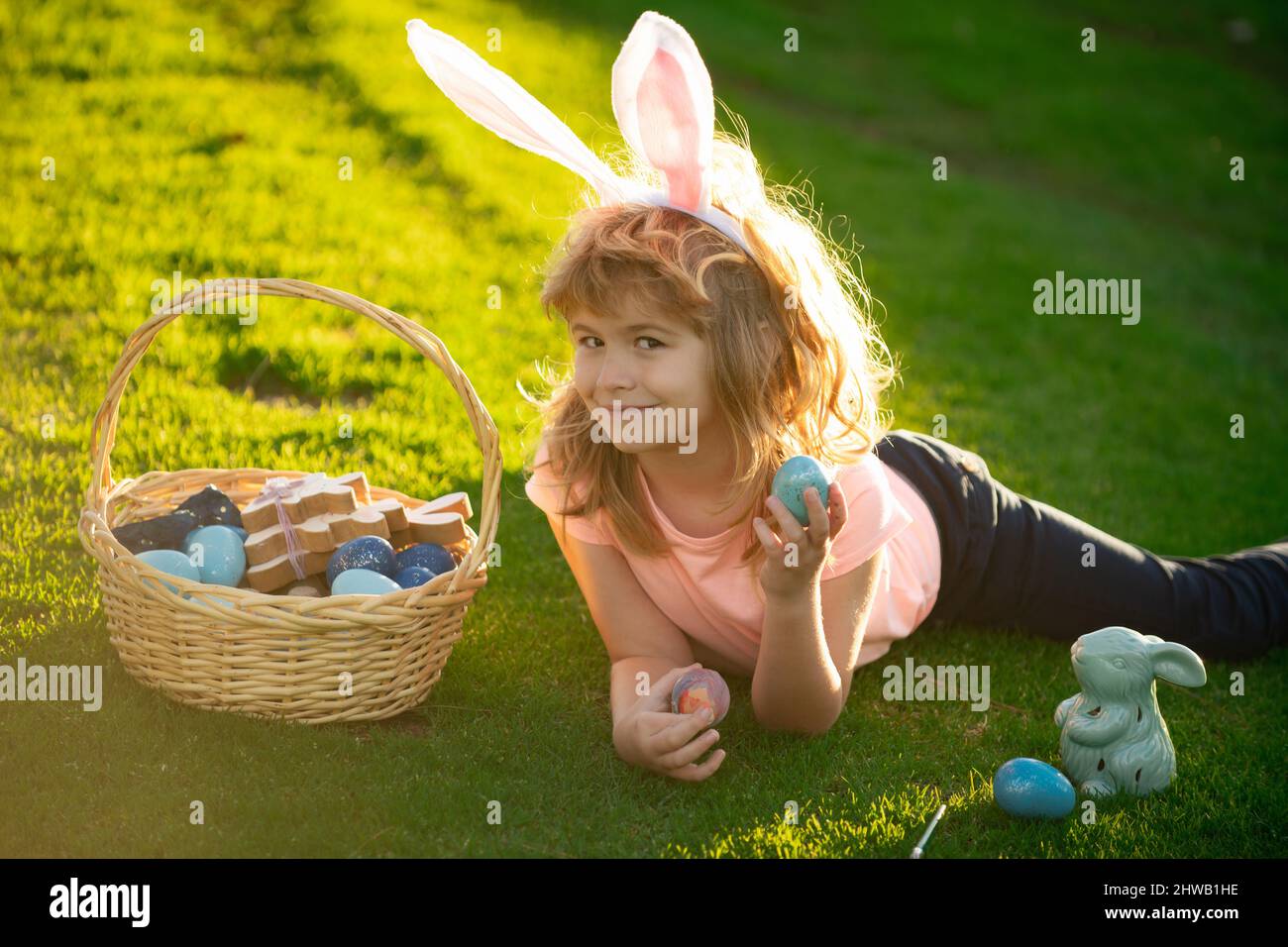 Children celebrating easter. Kid in rabbit costume with bunny ears ...