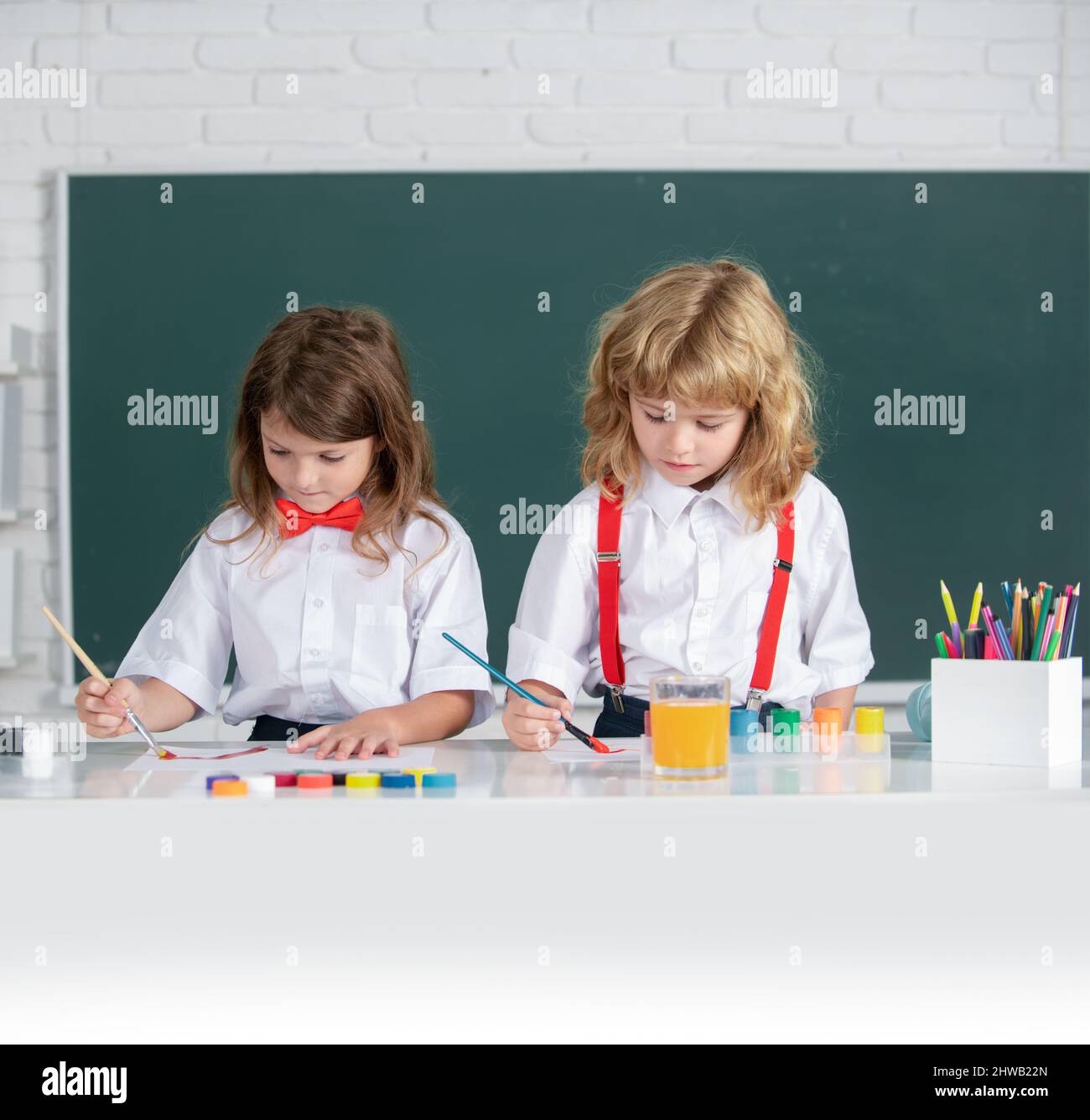 Cute friends kids drawing and painting at school. Friendly boy an girl ...
