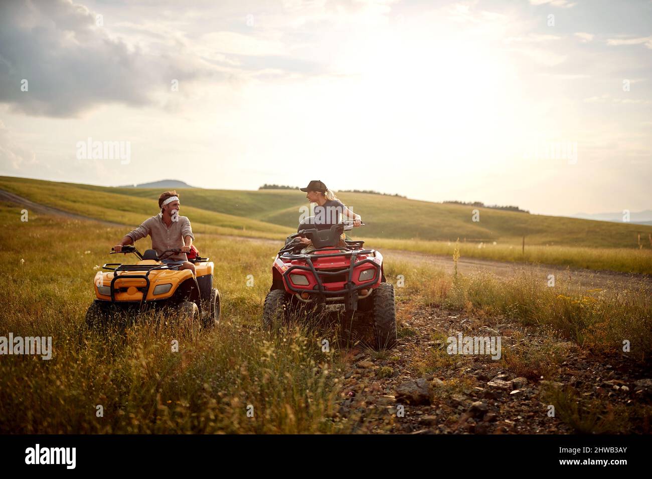 Young man and girl driving off-road and enjoying on extreme riding ...