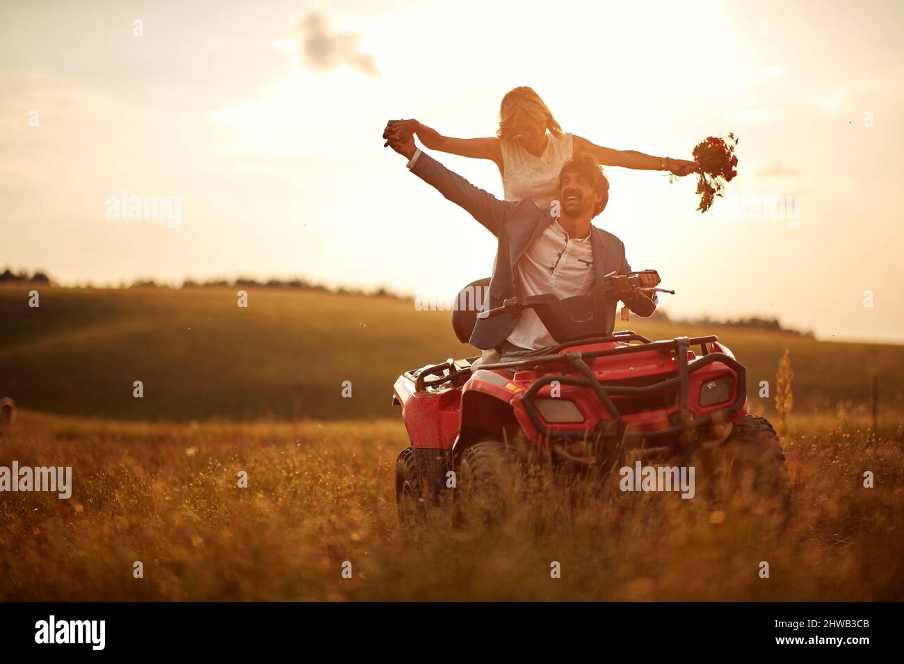 Wedding in nature.Happy young man and woman enjoying a quad atv vehicle ...