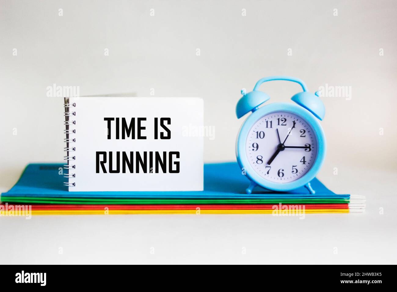Time is running, text on notepad with clock on white background Stock ...
