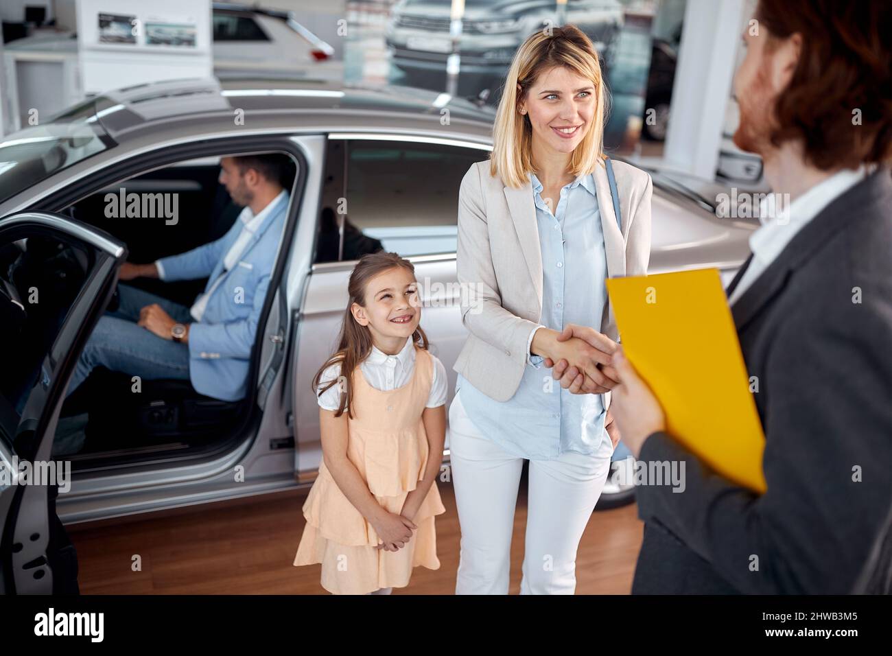 Caucasian family buying a new car together for themselves Stock Photo ...