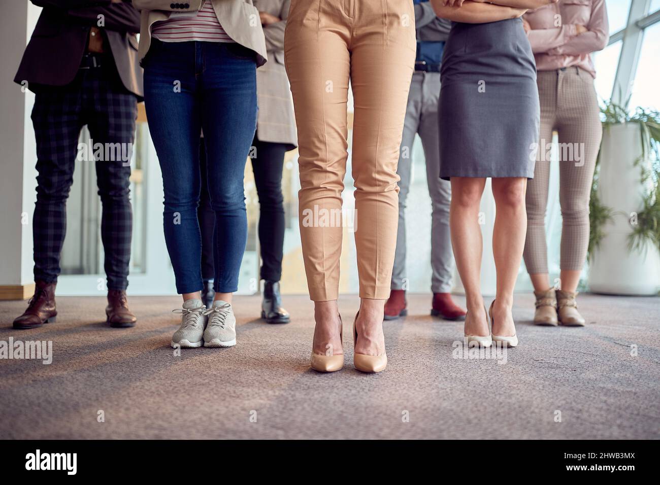 Close-up shot of young business team's legs standing in a pleasant ...