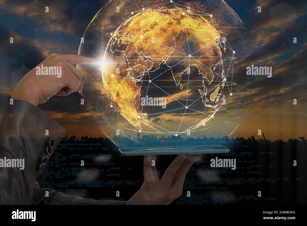 Hand holding the lablet and pointing the particle of earth over the ...