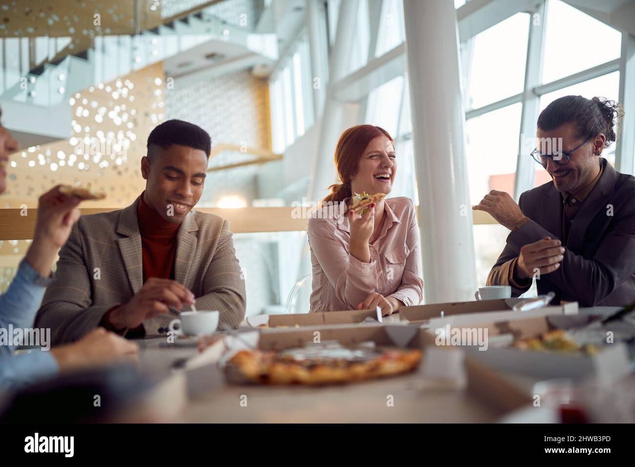 Young business team is having a good time during a lunch break in a ...