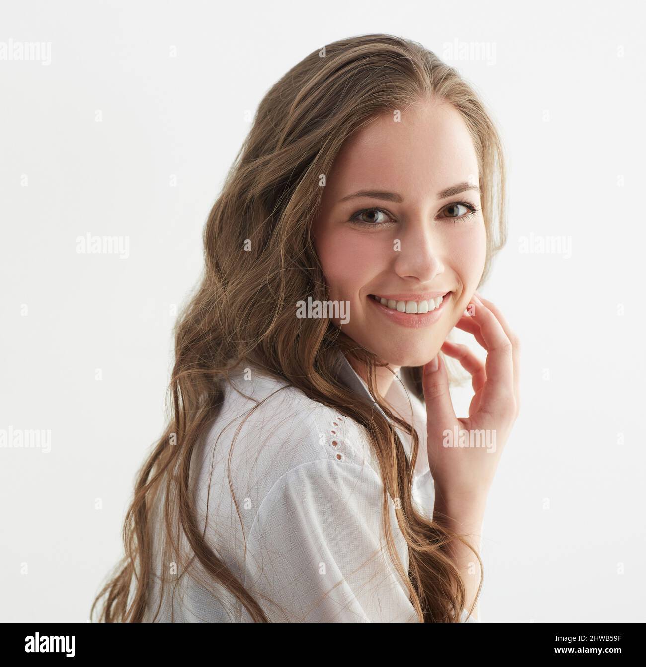 Just a little look back.... Studio shot of a young woman looking over ...