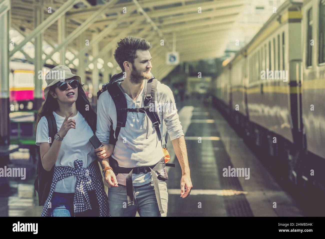 Multiethnic Travellers are walking and finding the train at the train ...