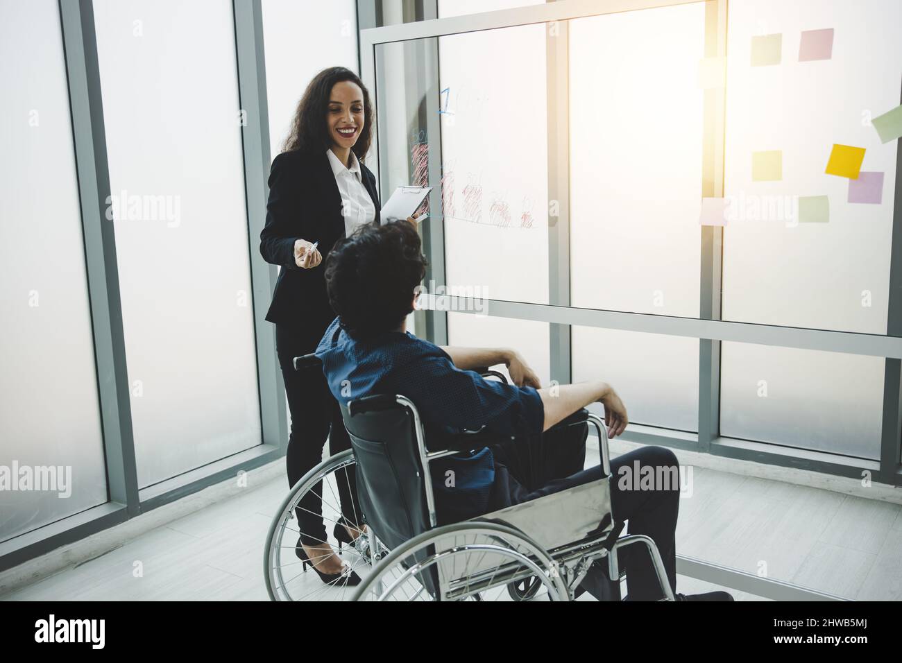 handicapped and disability business man sitting on wheelchair working ...