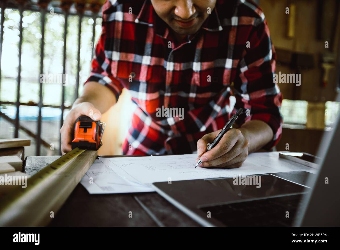 carpenter or architect looking and sketch on paper working in site work ...