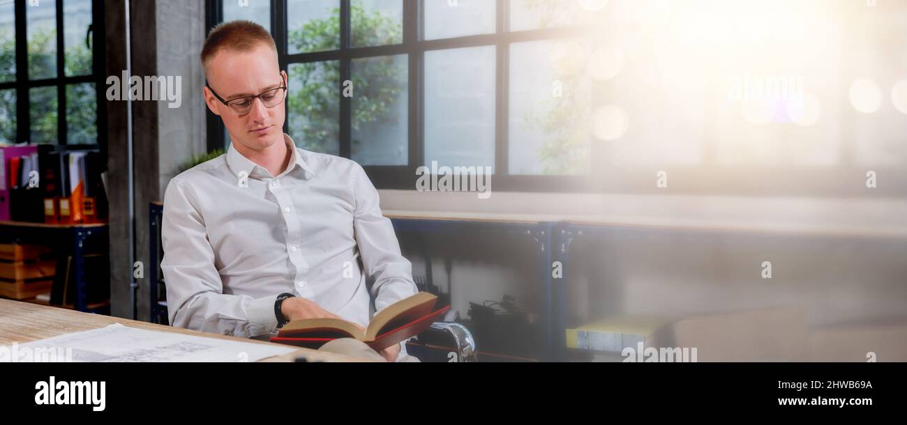 business man relaxing and reading book in office, man research and ...