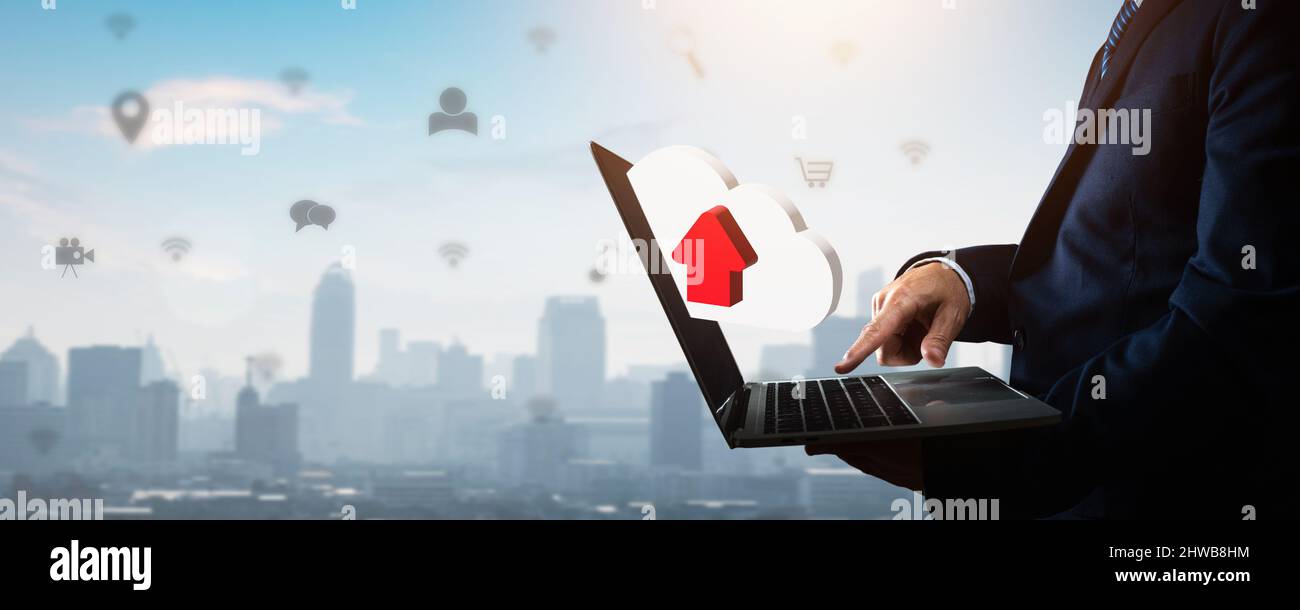 Businessman holding computer laptop and uploading data on cloud server with connection and ...