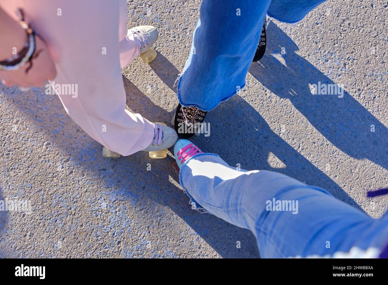 Top view of three feet with classic skate boots outdoors Stock Photo ...