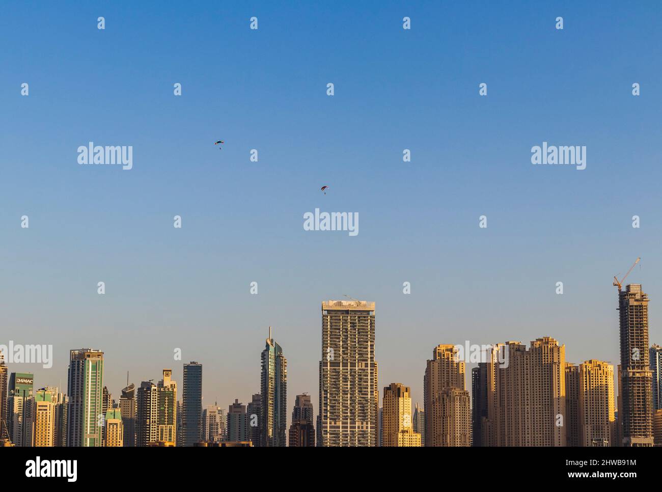 Parachutes over the city towers Stock Photo - Alamy