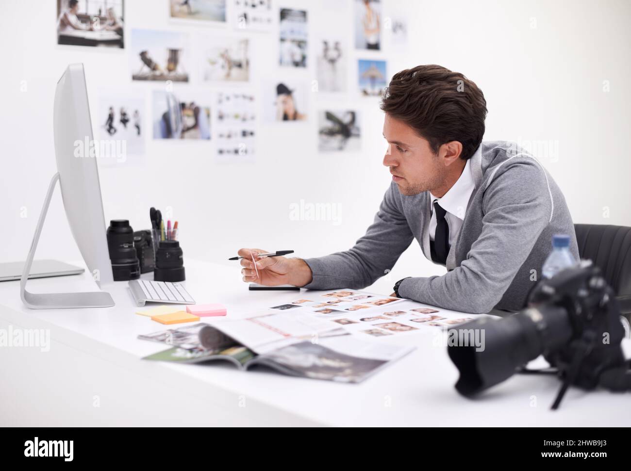 Making his final selection. A photographer looking at his images in his ...