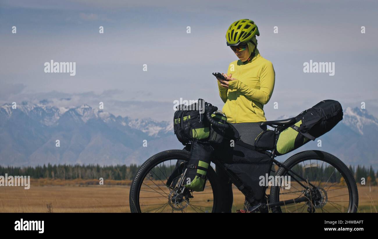 The woman travel on mixed terrain cycle touring with bikepacking. The ...