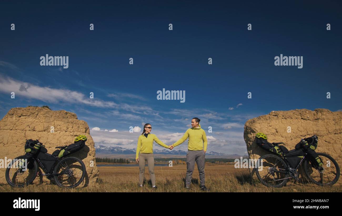 The man and woman travel on mixed terrain cycle bike touring with ...