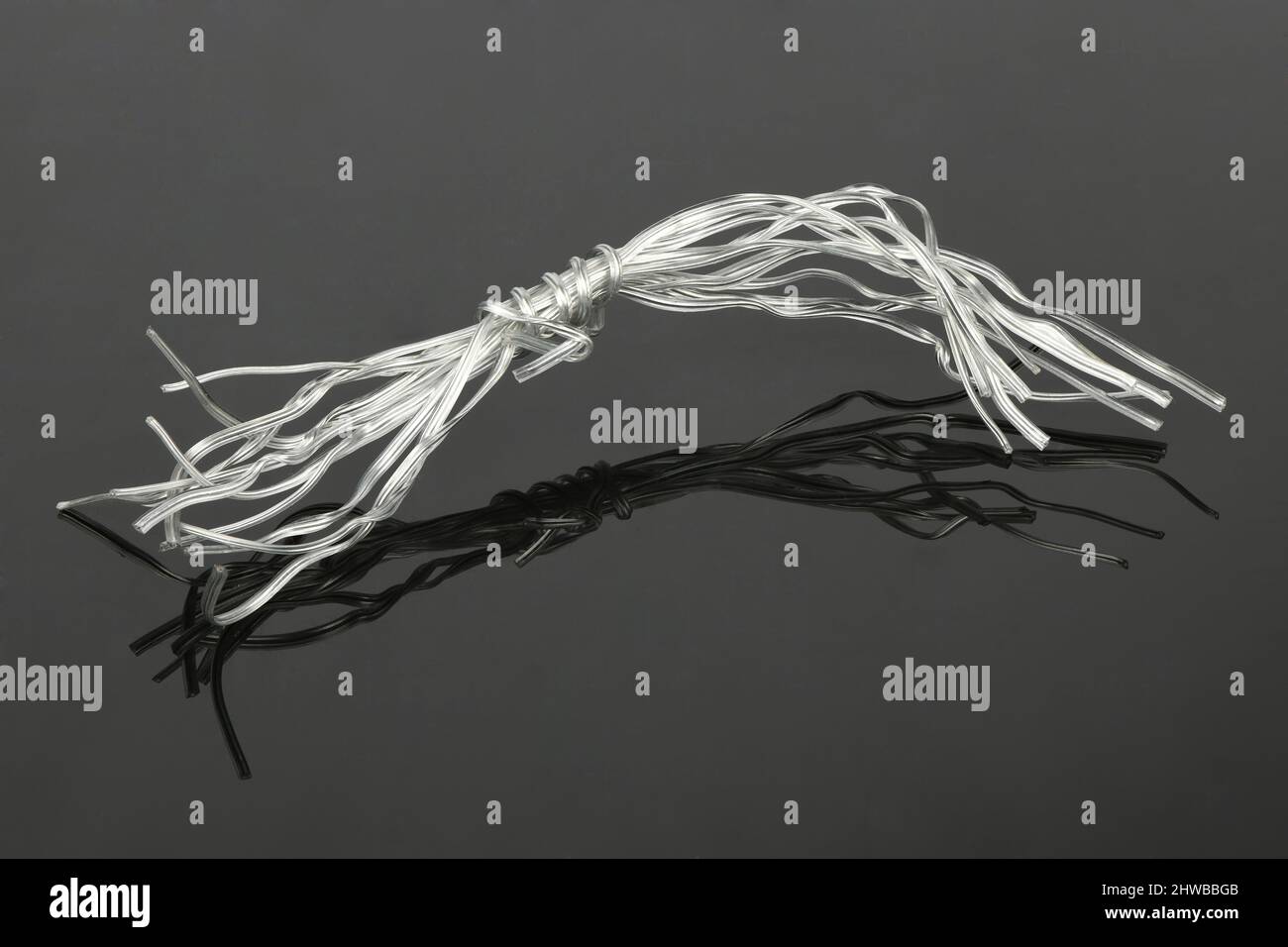 White plastic coated wire tie used for a variety of things on black ...