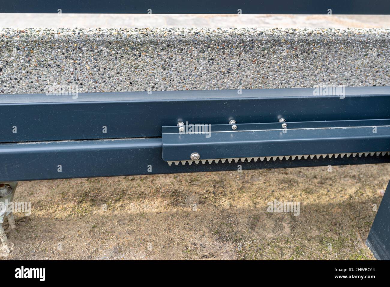 Modern sliding entrance gate in anthracite color, visible metal toothed ...