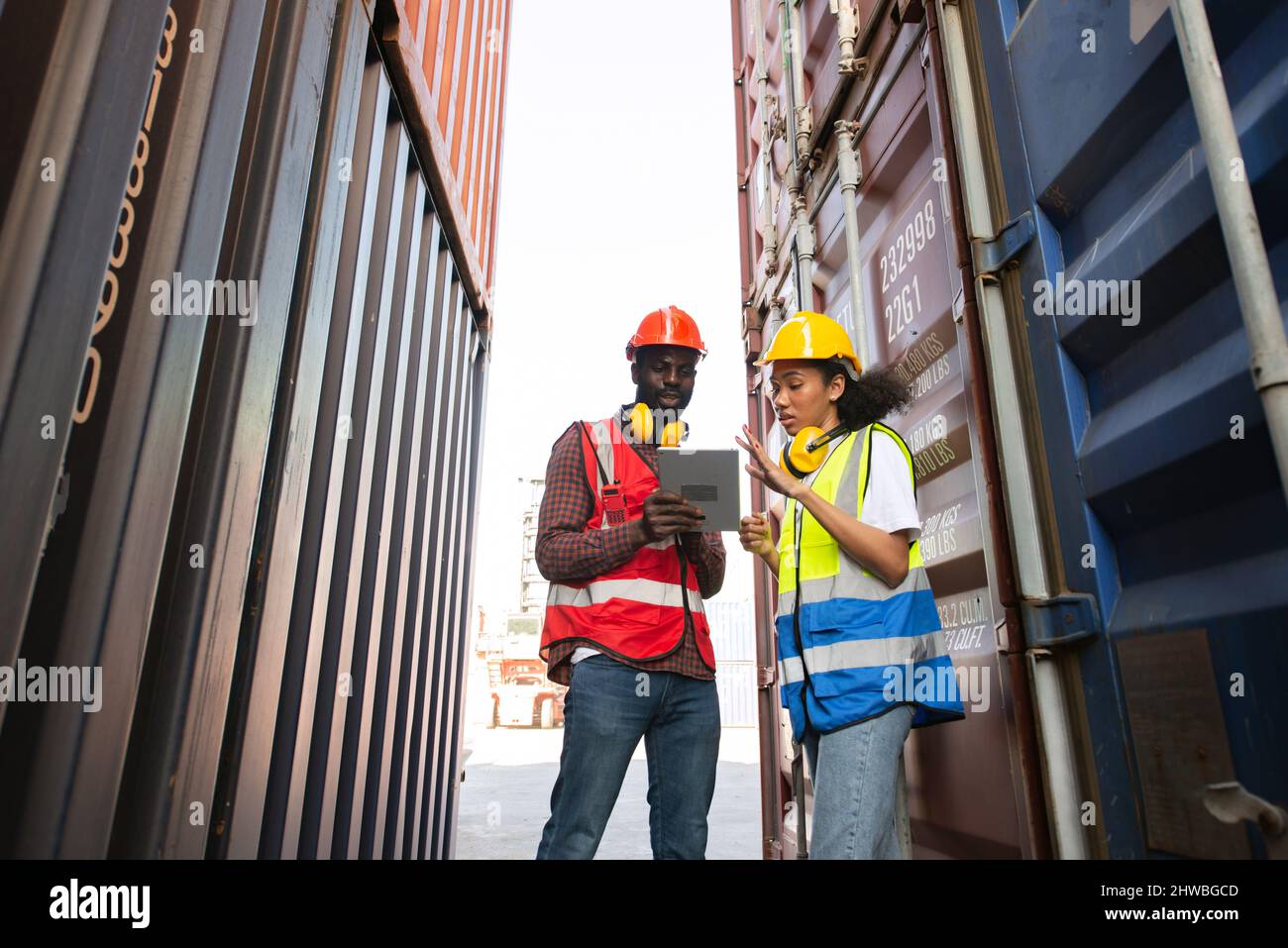 Two African american male and female worker using tablet and checking ...