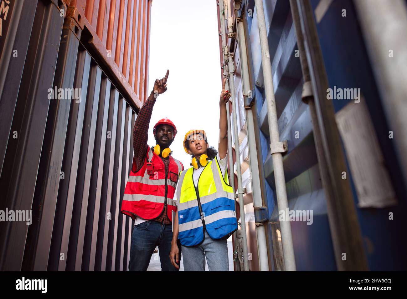 Two African american male and female worker check and control loading ...