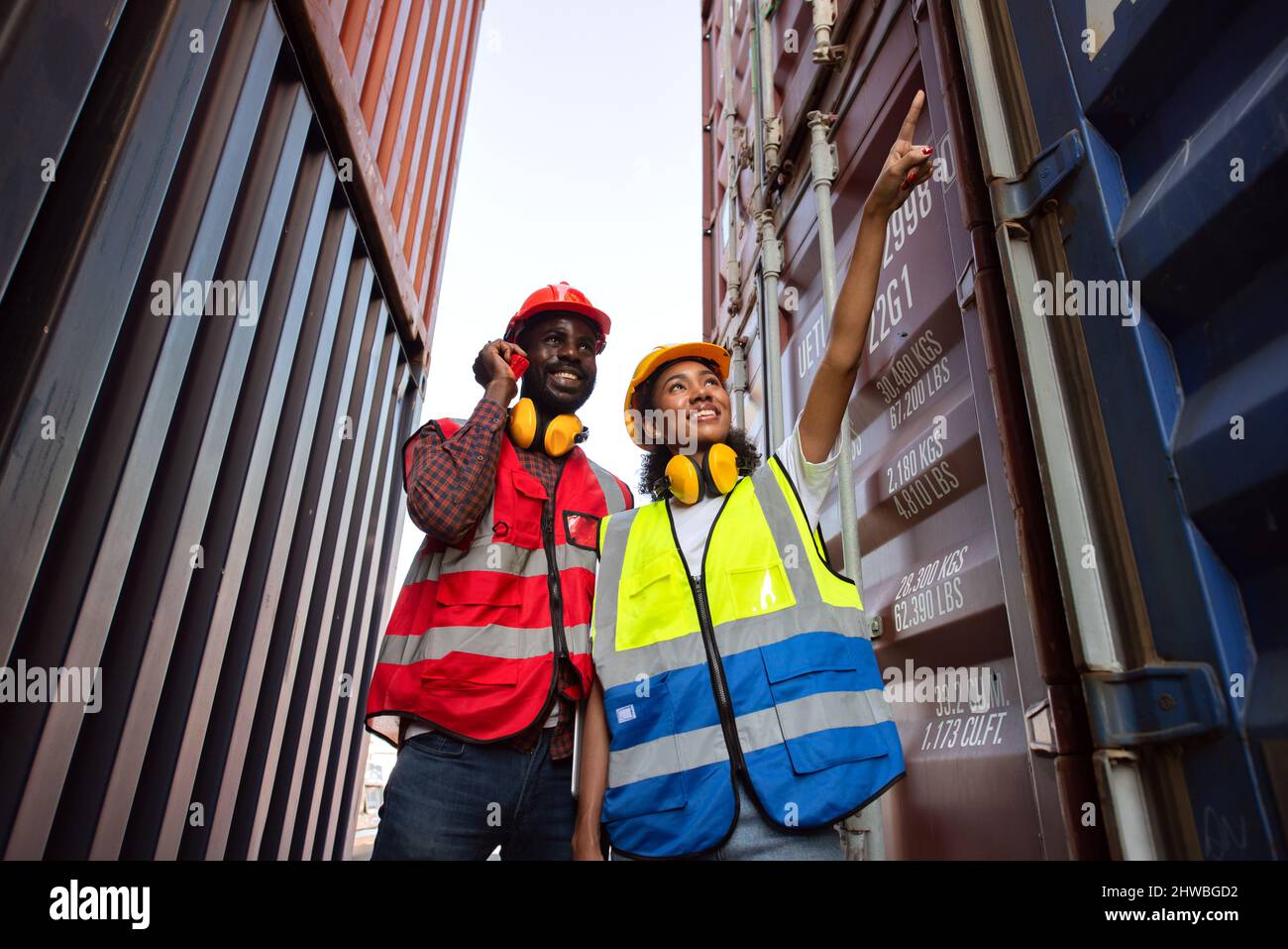 Two African american male and female worker using radio communication ...