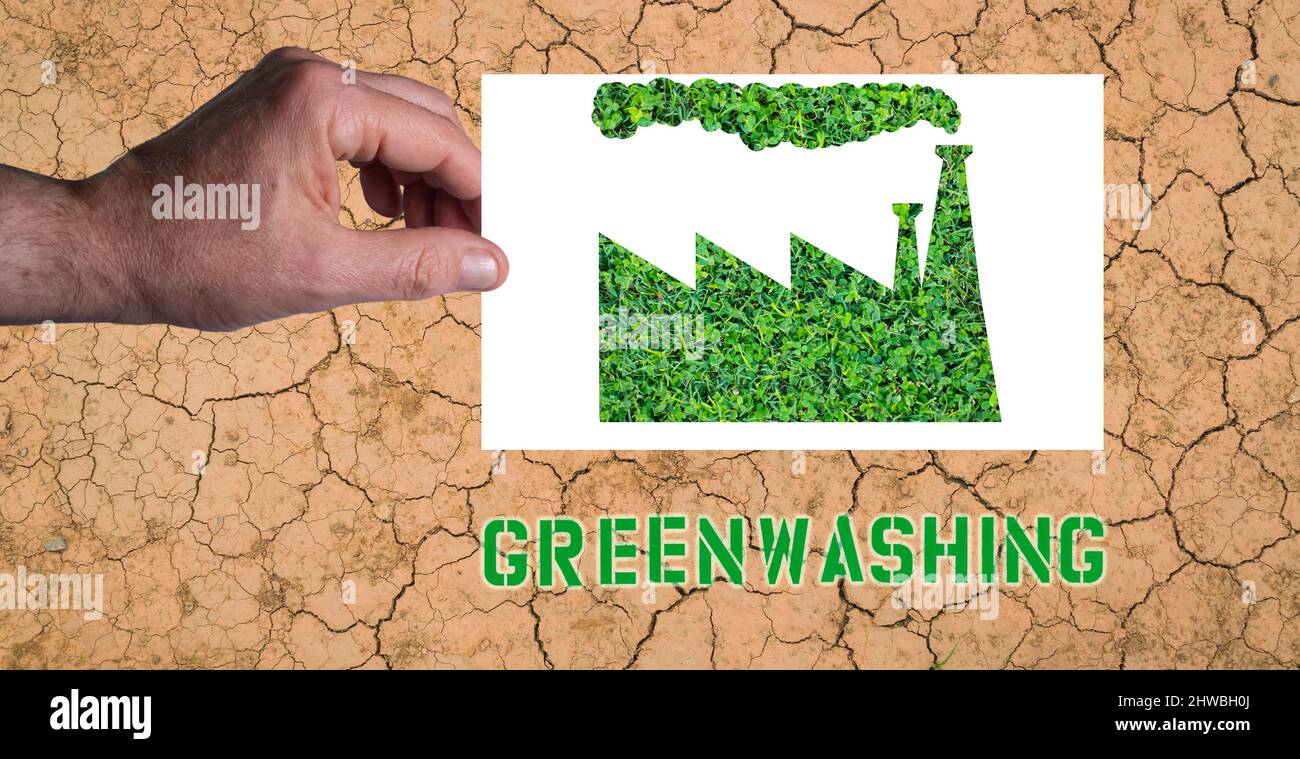 Greenwashing: A man's hand holds a white sheet of paper with the ...