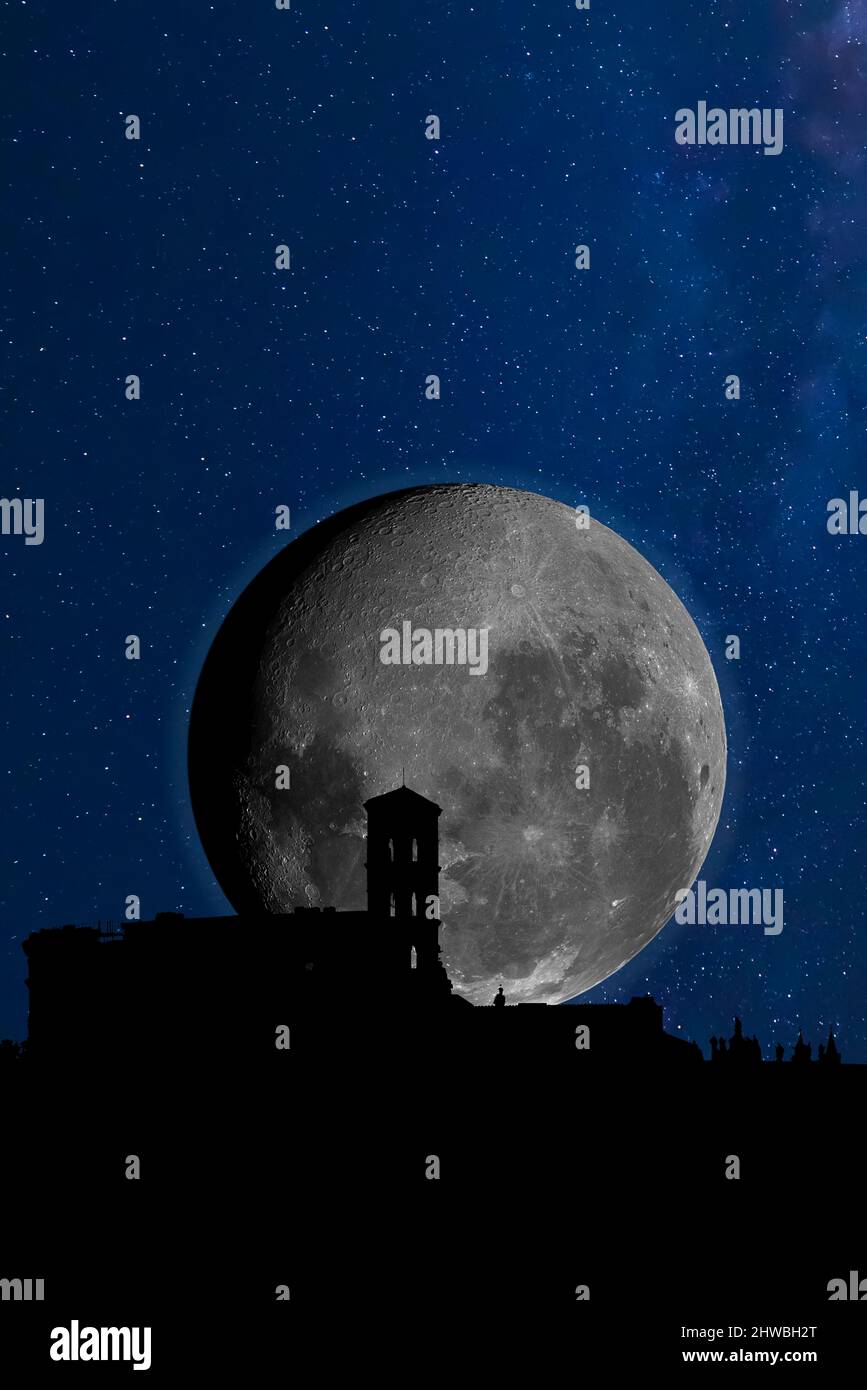 Backlit skyline of Rome with the Colosseum, a church and the rising ...