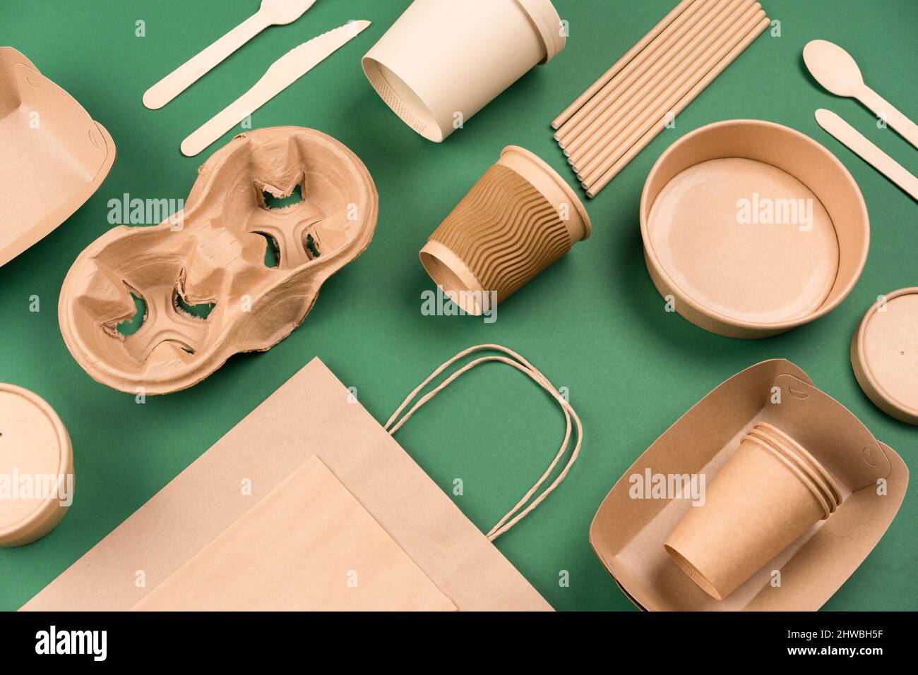 Eco-friendly tableware - kraft paper utensils on green background ...