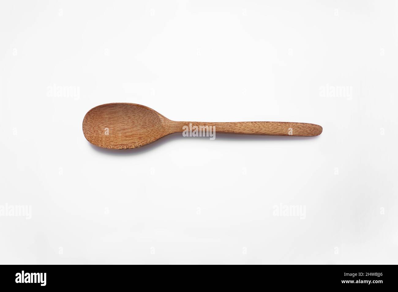 Wooden rustic spoon on white background Stock Photo - Alamy