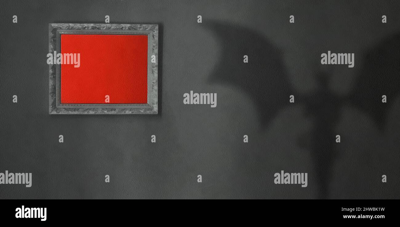 Shadow of the Devil on a dark wall, red background inside a wooden ...