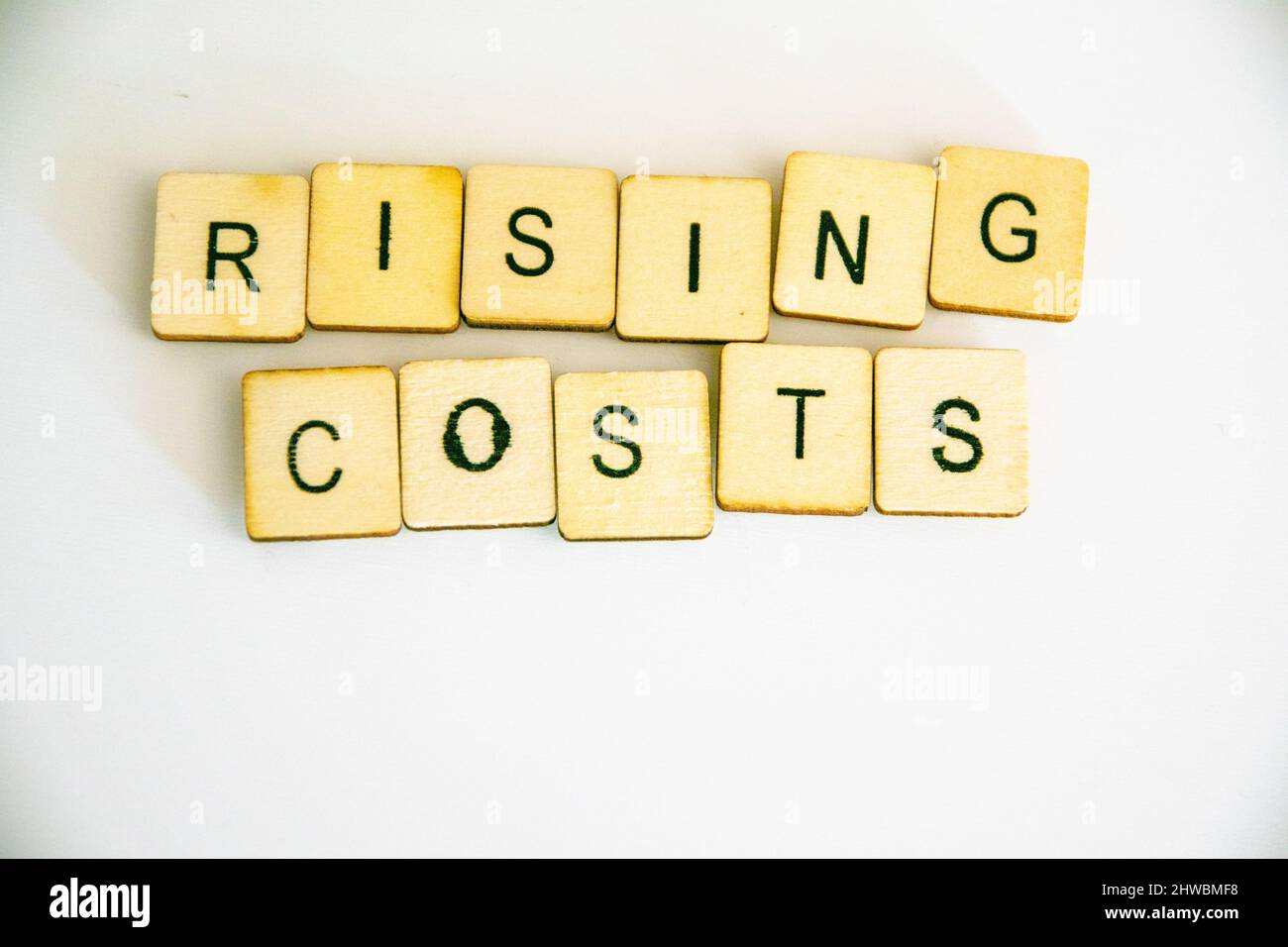 Rising Costs text on vintage wooden squares. Background concept for ...