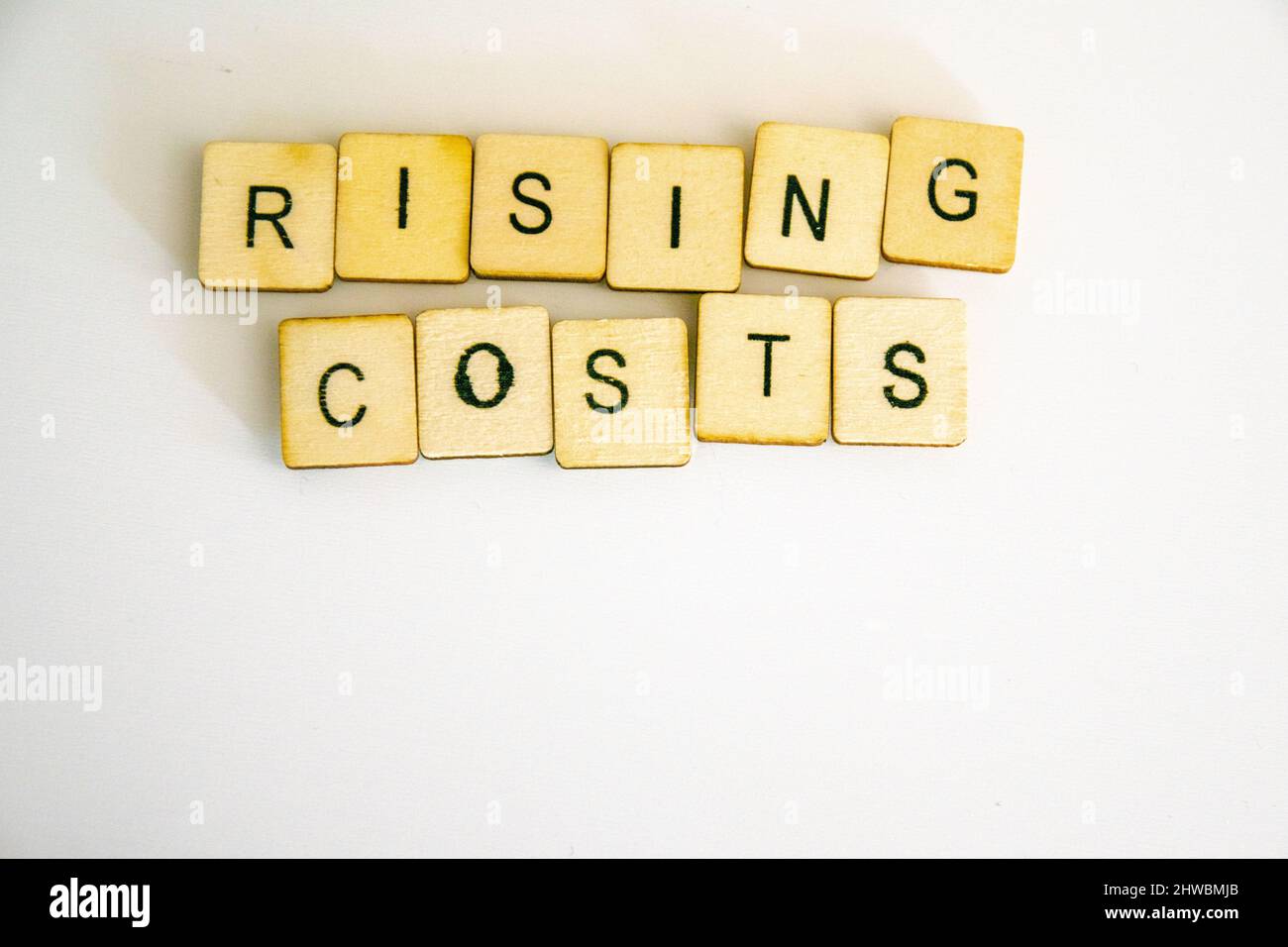 Rising Costs text on vintage wooden squares. Background concept for ...