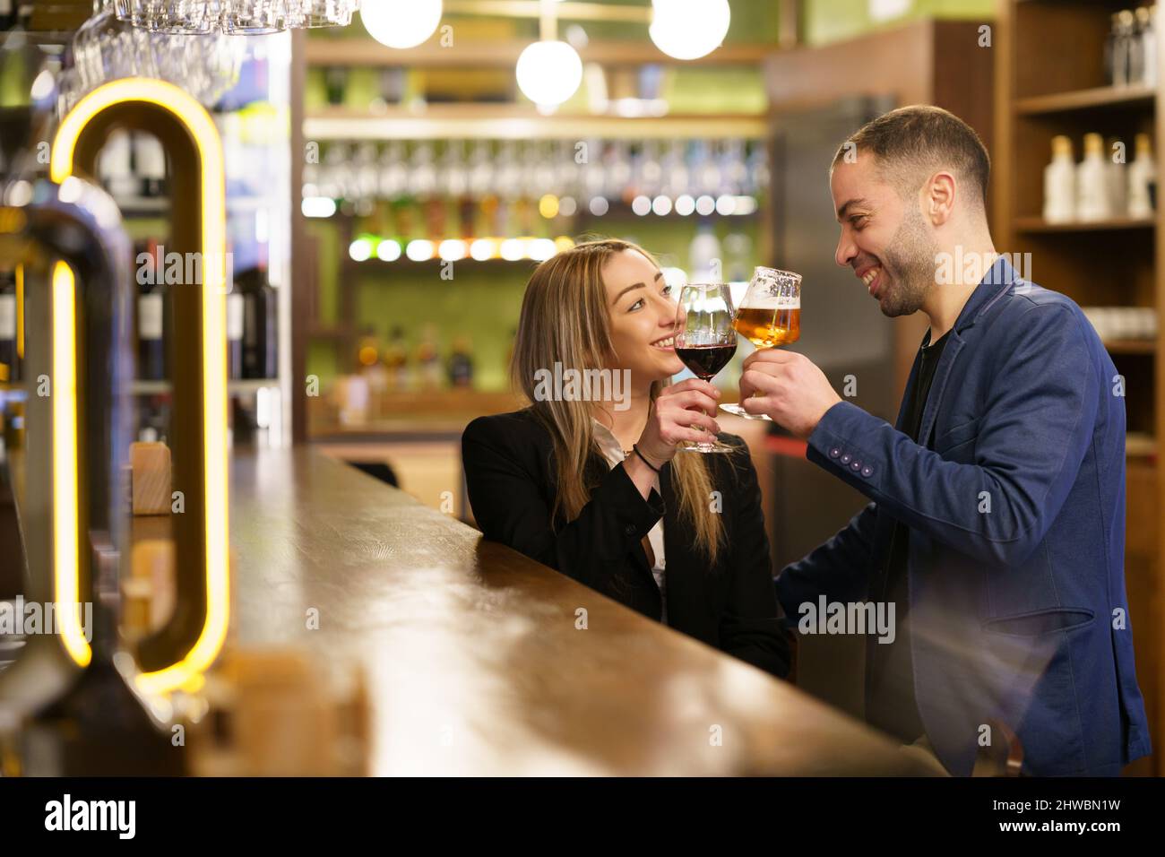 Multiethnic couple proposing toast in a pub Stock Photo - Alamy