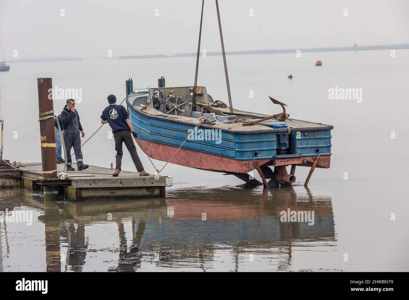 Lifting a boat into the River Crouch at Burnham on Crouch Stock Photo ...