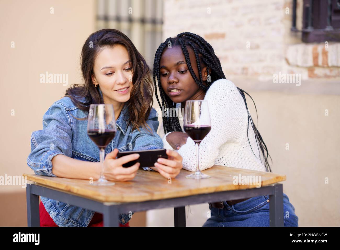Diverse women chilling in street cafe together Stock Photo - Alamy