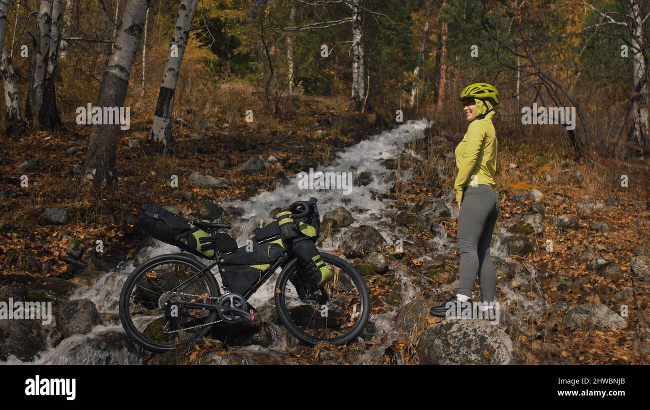 The woman travel on mixed terrain cycle touring with bikepacking. The ...