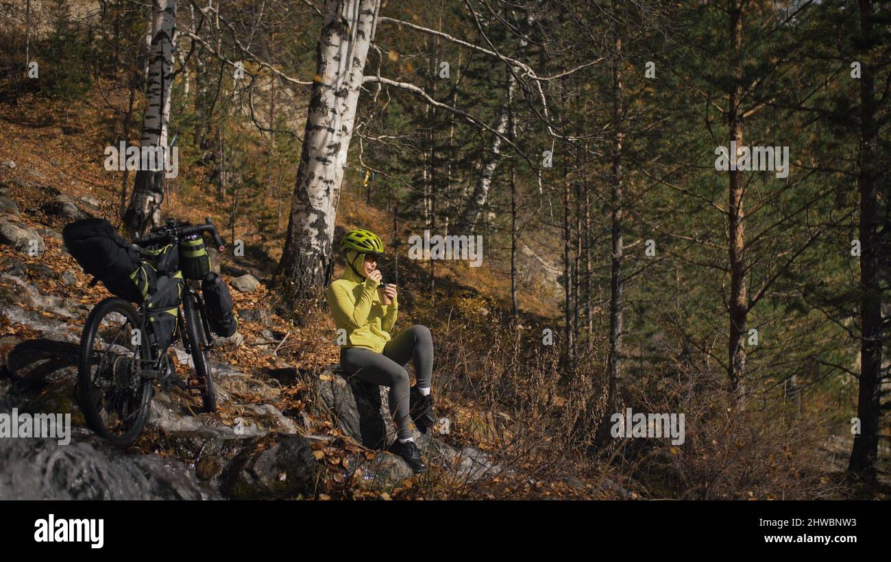 The woman travel on mixed terrain cycle touring with bikepacking. The ...