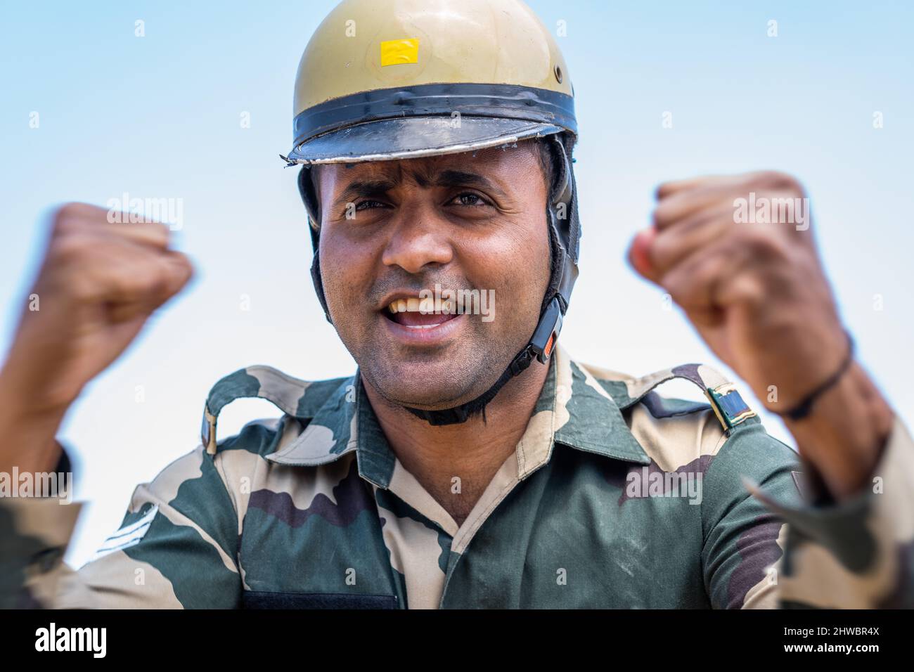 excited army service man shouting by looking at camer while in the ...