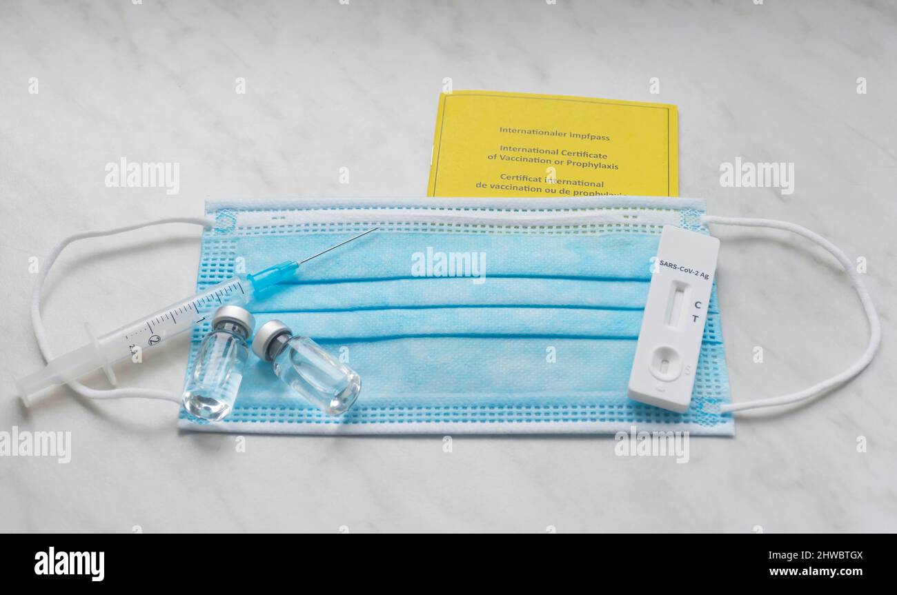 Medical mask, antigen test, vaccination certificate, vaccine bottles ...
