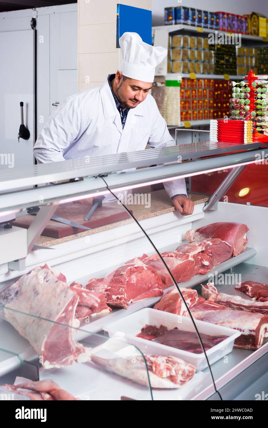 Portrait of smiling european male butcher in kosher section at ...